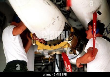 Members of the 96th Munitions Maintenance Squadron inspect an inert AGM ...