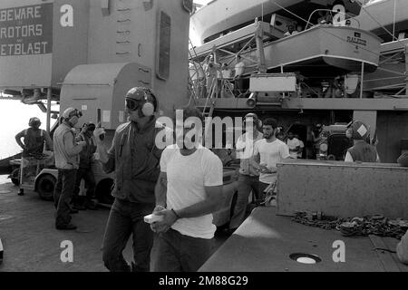 A crew member from the amphibious transport dock USS DULUTH (LPD 6 ...