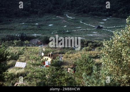 Two airmen work on a piece of equipment at the Pil Sung bombing range's ...