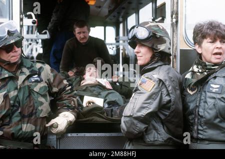 Members of the 1ST Aeromedical Evacuation Squadron carry a "patient ...