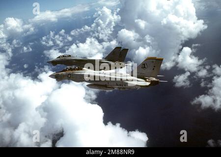 A Fighter Squadron 142 (VF-142) F-14A Tomcat aircraft is lowered by ...