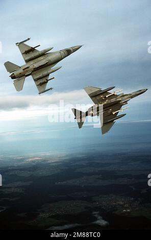 An air-to-air view of the underside of an F-4G Phantom II aircraft ...