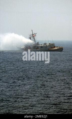 USS Stark (FFG-31) listing after missile hit in the Persian Gulf on 18 ...