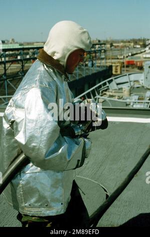 A marine aboard the aviation logistic ship USNS WRIGHT (T-AVB 3) looks ...