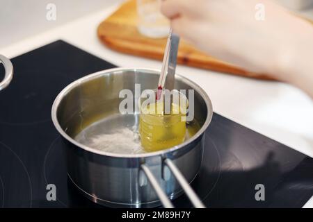Heat beakers of water and jojoba oil in boiling water, record the ...