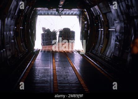 Fuel containers drop from a C-141B Starlifter aircraft during a ...