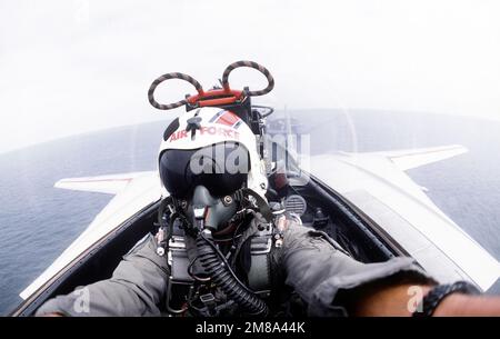 A pilot and radar intercept officer from Fighter Squadron 143 (VF-143) sit in the cockpit of ...