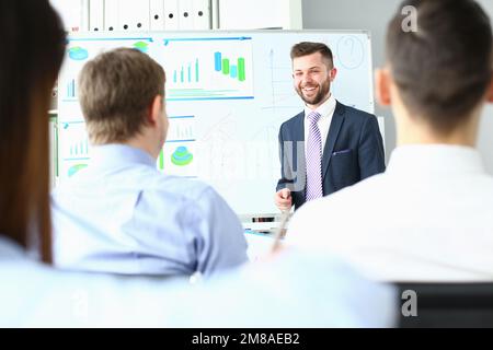 Smiling boss conducts business training for employees Stock Photo - Alamy