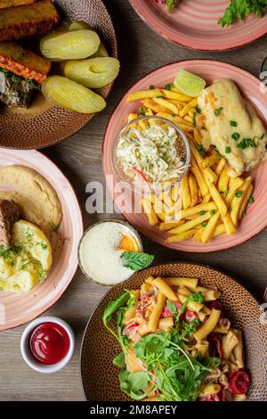 Top view of assorted round plates with various of sweet colorful French ...