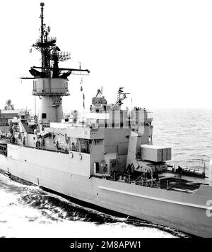 A starboard amidships view of the frigate USS COOK (FF-1083) moored ...