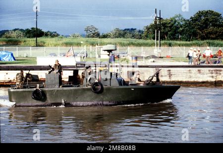 Crewmen aboard a US Navy PBR Mark 2 river patrol boat keep watch as ...