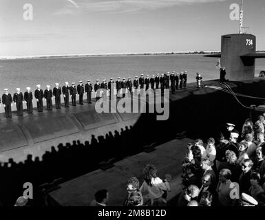 Crewmen stand on the deck of the nuclear-powered attack submarine USS ...