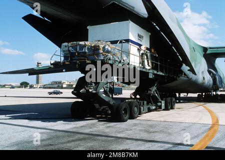 Airmen from the 603rd Military Airlift Support Group secure a piece of ...