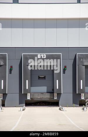 Row of loading docks with shutter doors. Warehouse gates for loading ...