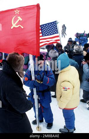 Members of the joint Soviet-American Bering Bridge Expedition listen to ...