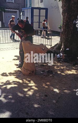 Woodcarver at the traditional festival of the donkey in La ...