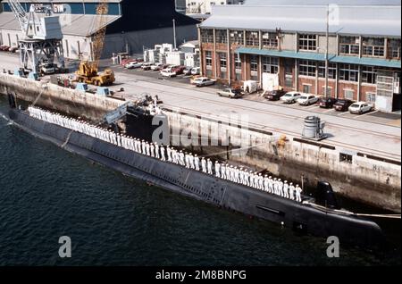 Crew members man the rails aboard the nuclear-powered guided missile ...