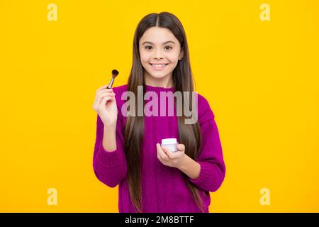 Kids make up products. Makeup teen child artist apply face powder with ...