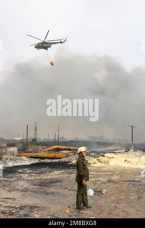 Cuban armed forces helicopter putting out the fire from the explosion ...