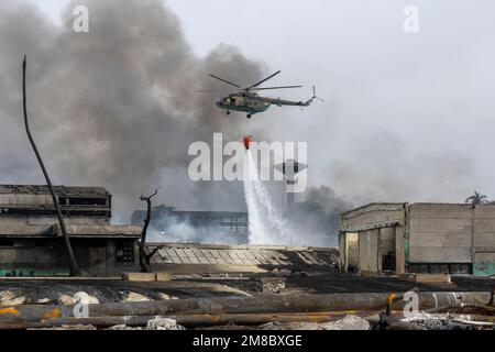 Cuban armed forces helicopter putting out the fire from the explosion ...