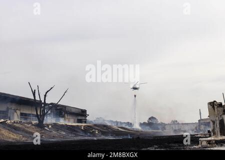 Cuban armed forces helicopter putting out the fire from the explosion ...