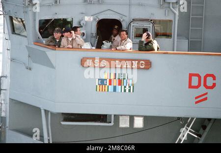 Crew members watch from the bridge of the ocean minesweeper USS INFLICT ...