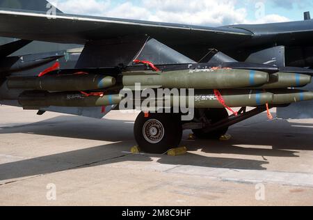 A view of ten BDU-50 practice bombs mounted on pylons beneath the left ...