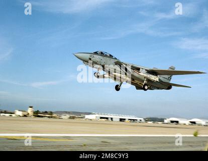 A Fighter Squadron 211 (VF-211) F-14A Tomcat aircraft is lowered by ...