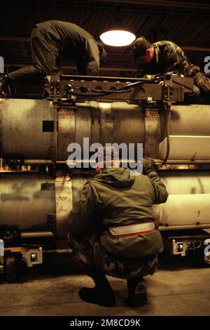 Airmen from the 42nd Munitions Maintenance Squadron prepare to load a ...