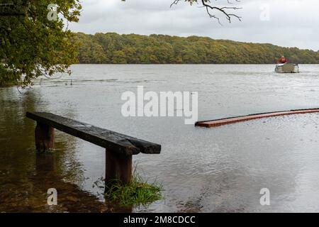bench surrounded by water at high tide in the River Hamble Hampshire ...