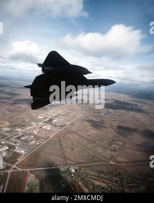 An air-to-air left side view of an SR-71A aircraft being refueled by a ...