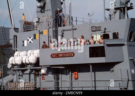 Crew members watch from the bridge of the ocean minesweeper USS INFLICT ...
