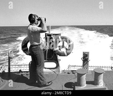 A sailor stands watch on the fantail of the nuclear-powered aircraft ...