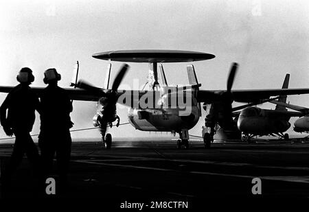 An E-2C Hawkeye aircraft catches the arresting cable as it lands on the ...