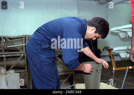 Weapons technicians aboard the nuclear-powered aircraft carrier USS ...