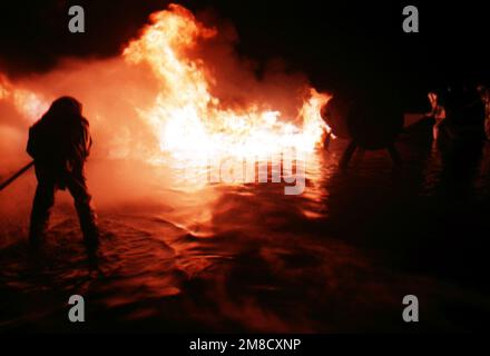 Dressed in proximity suits, two Marines of the air station's crash and ...