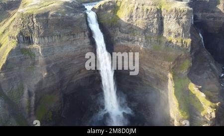 A Drone shot over Haifoss Waterfall in Iceland river Fossa on a sunny ...