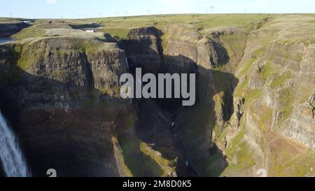 A Drone shot over Haifoss Waterfall in Iceland river Fossa on a sunny ...