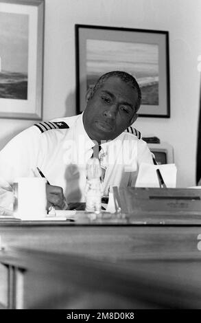CAPT Mack C. Gaston tends to paperwork in his office at the Pentagon ...