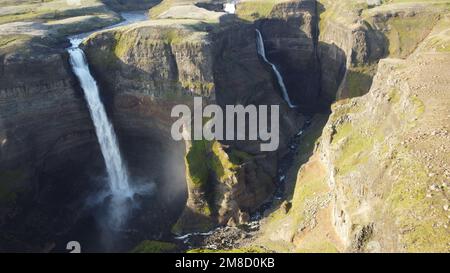 A drone shot over Haifoss Waterfall in Iceland river Fossa on a sunny ...