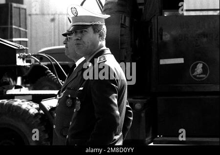 Tunisian army officers watch the unloading of equipment from the dock ...
