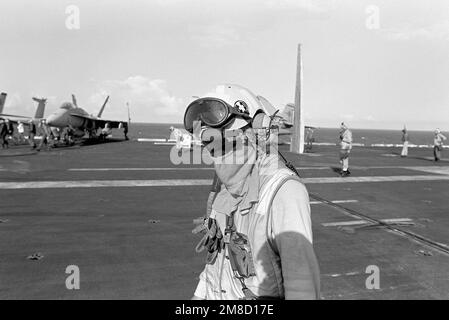 An aircraft handler aboard the nuclear-powered aircraft carrier USS ...