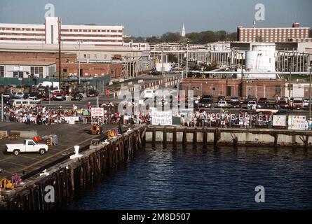 Family members and friends wait for the amphibious assault ship USS ...