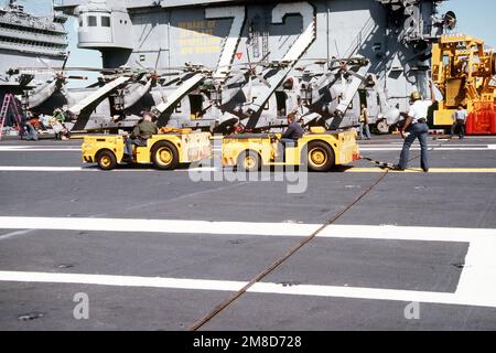 Crew members position MD-3A tow tractors to test the tension level of ...