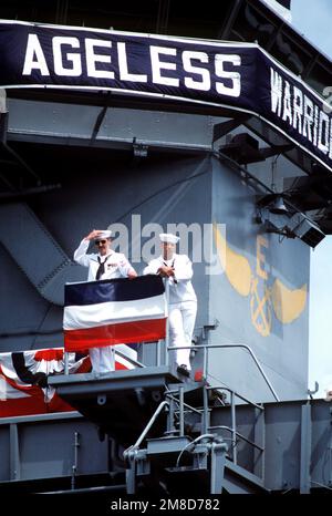 Crew members watch from the bridge of the ocean minesweeper USS INFLICT ...