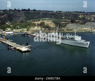 A starboard bow view of the submarine tender USS FULTON (AS 11) tied up ...