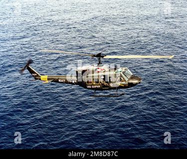 A right side view of a UH-1N Iroquois helicopter in flight. The ...