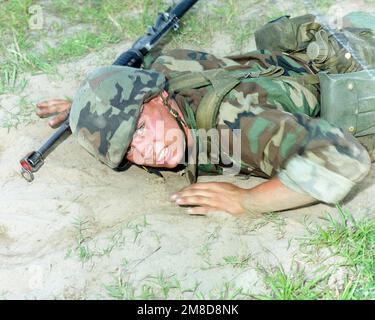 A 1ST Battalion recruit crawls on an infiltration course. Base: Usmc ...