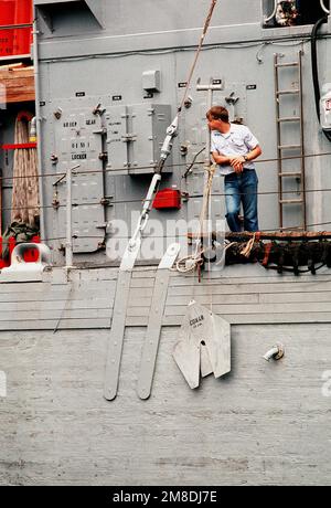 A crew member aboard the ocean minesweeper USS IMPERVIOUS (MSO-449 ...