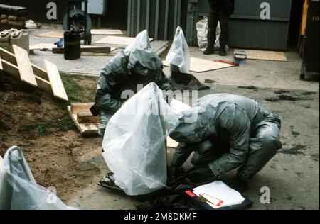 Chemical reaction team personnel wearing nuclear-biological-chemical ...